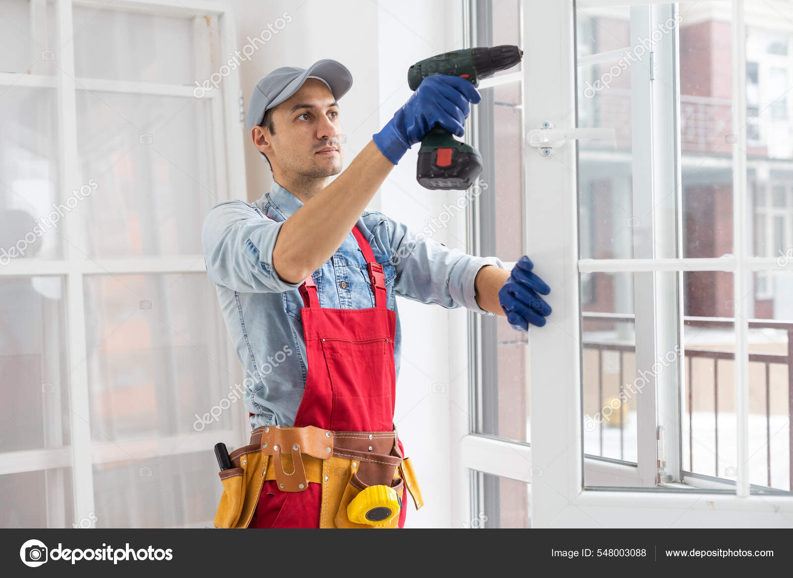 Handyman adjusting white pvc plastic window indoors. worker using ...