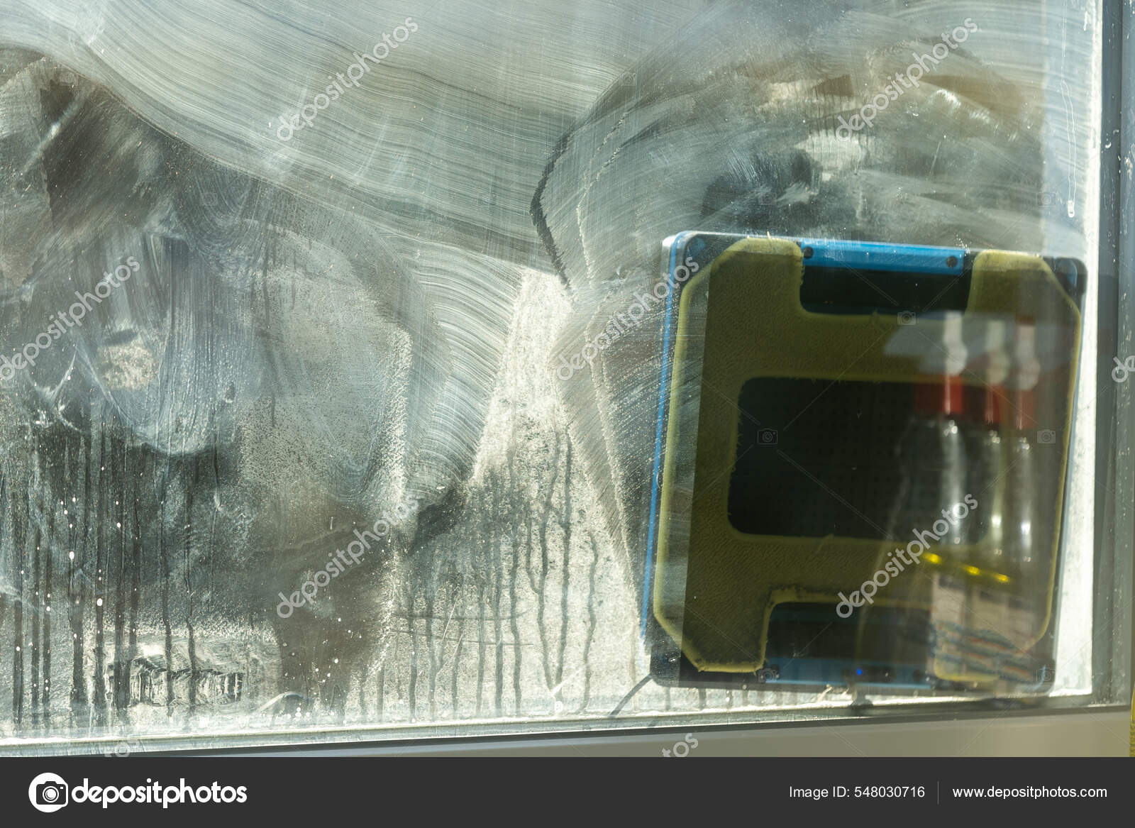 Window with very dirty and dusty glass in daylight. cleaning robot ...
