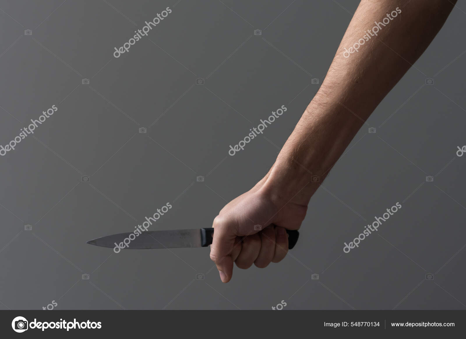 An aggressive man attacks with a knife. Stabbing attack. Hand with a ...