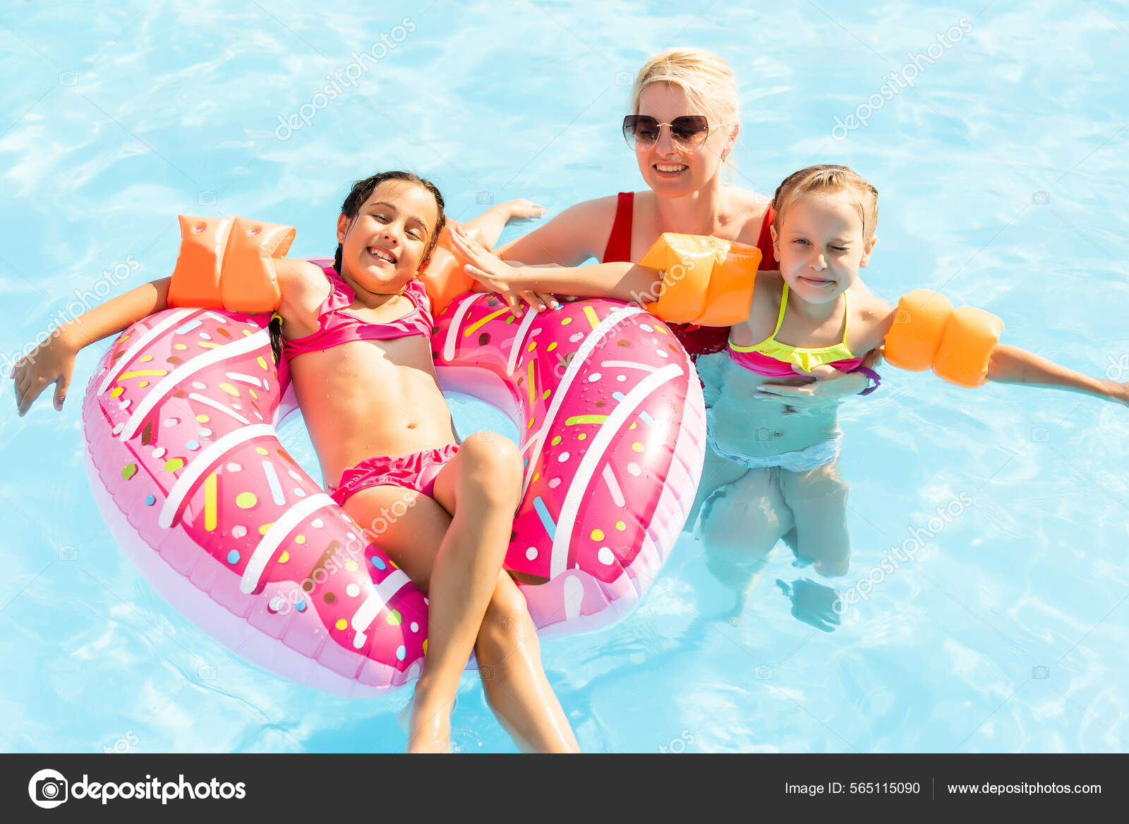 Niños jugando en la piscina. Dos niñas divirtiéndose en la piscina. Vacaciones de verano y ...