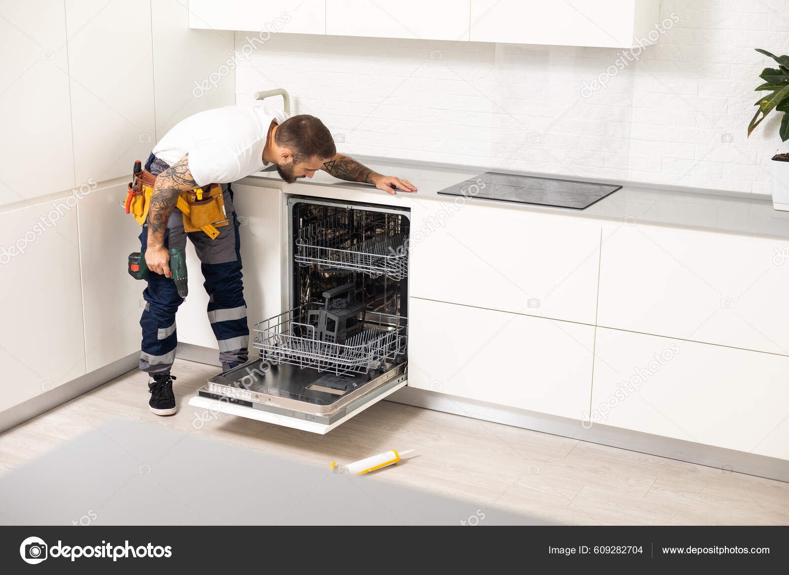 Young Modern Serviceman Worker Suit Repairing Dishwasher Domestic ...