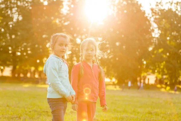 two little friends girls in the field - Stock Image - Everypixel