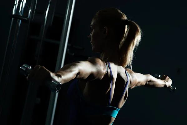 Female athlete straining back muscles and arms — Stock Photo ...