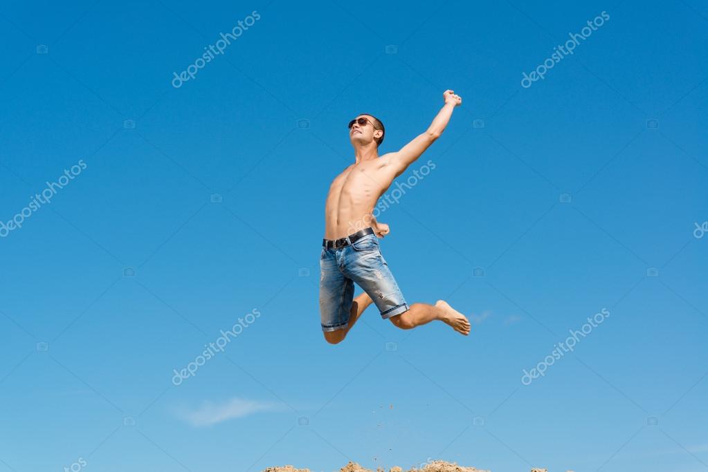 Young man jumping Stock Photo by ©Khakimullin 24440173