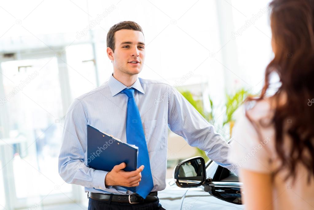 Sales manager at a showroom car — Stock Photo © Khakimullin #26601301