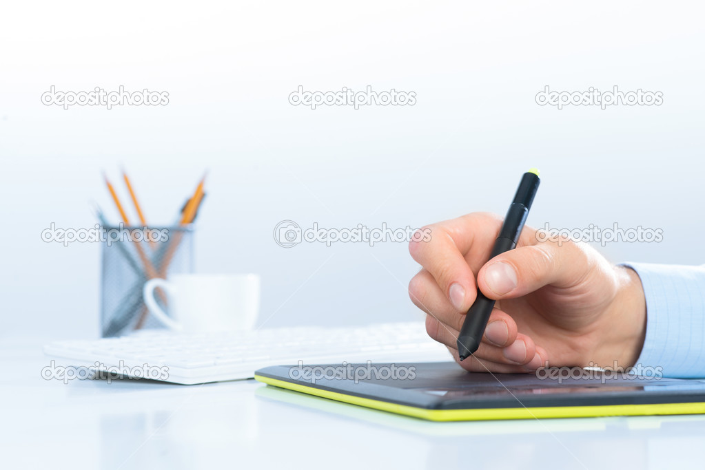 Designer hand drawing a graph on the tablet Stock Photo by ©Khakimullin ...