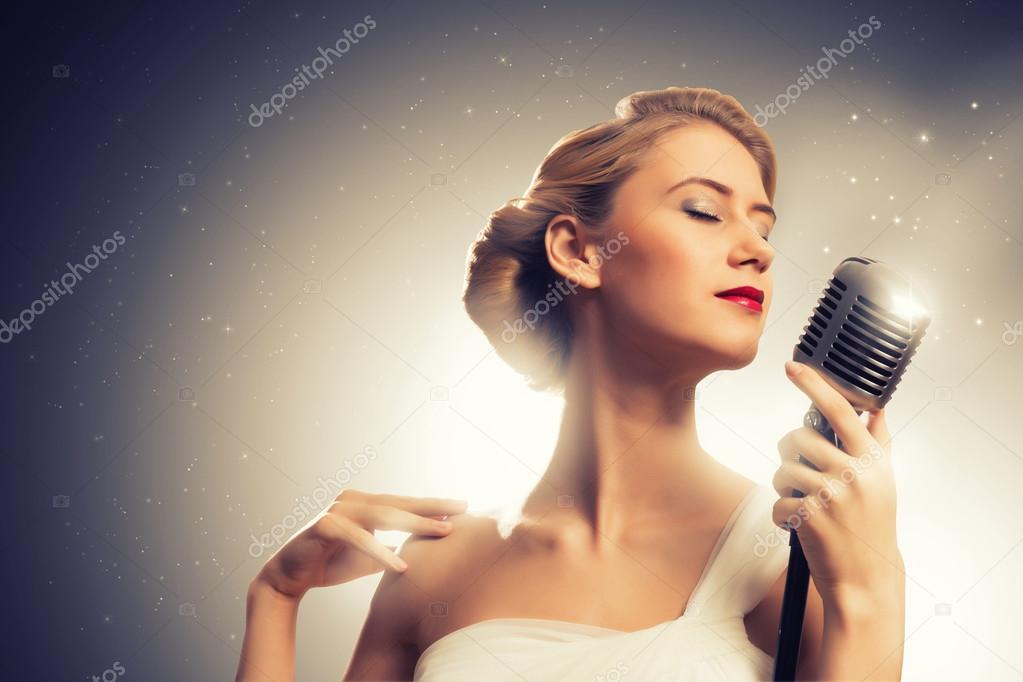 Attractive female singer with microphone — Stock Photo © Khakimullin ...