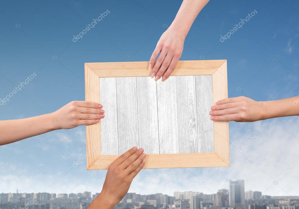 Hands holding frame Stock Photo by ©Khakimullin 47340567