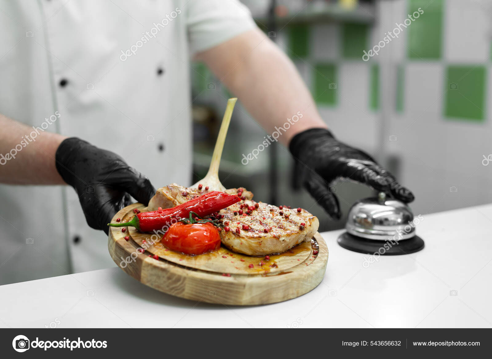Cook with a ready-made dish with meat and vegetables on a wooden Board ...