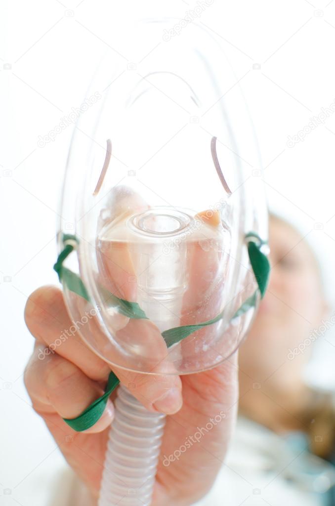 Female assisitant giving gas mask to patient Stock Photo by ...