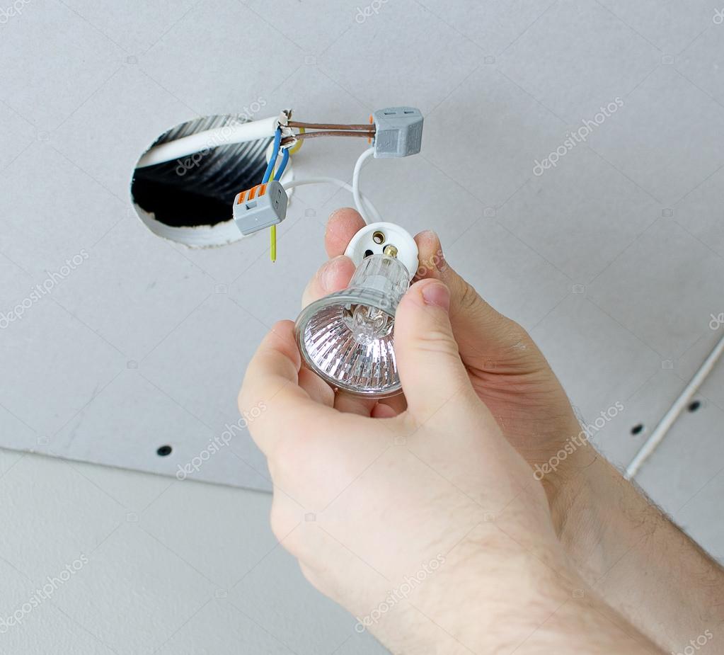 Male hands installing socket for light bulb Stock Photo by ©mproduction ...