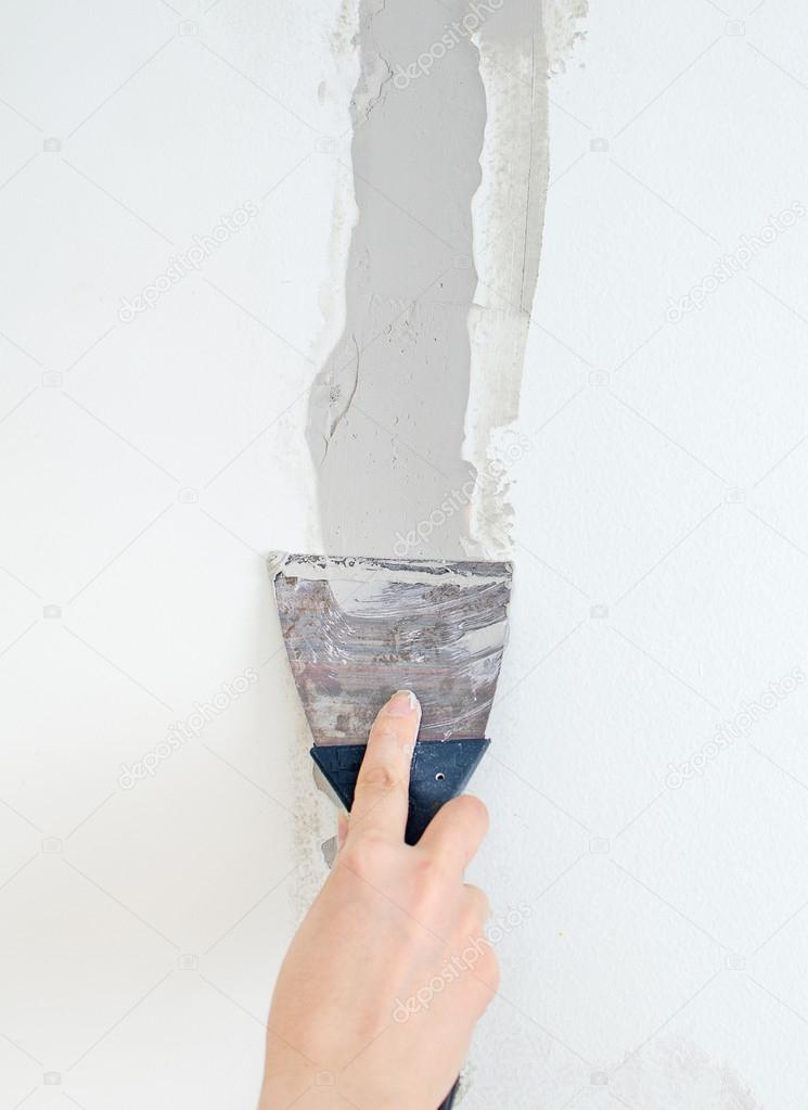 Female hand repairs wall with spackling paste — Stock Photo ...