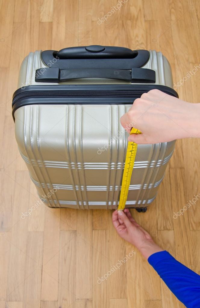 Hand luggage measurement using measuring tape. Stock Photo by ...