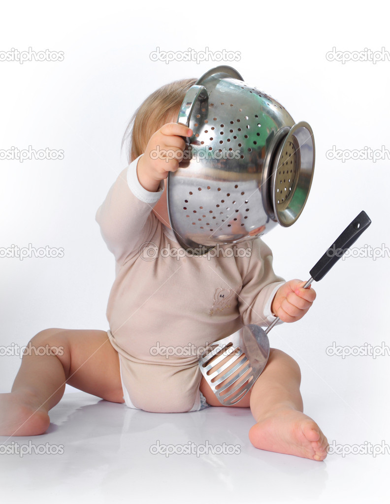 Baby boy in the kitchen pan — Stock Photo © yogo #13627295
