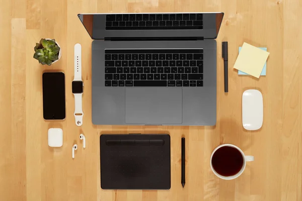 CONTENT CONCEPT Businessman tidy desktop with laptop, tablet ...