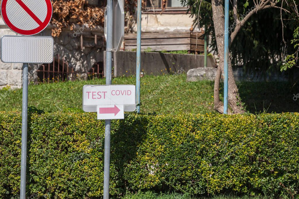 Sign indicating the direction to a Covid 19 testing facility, in ...