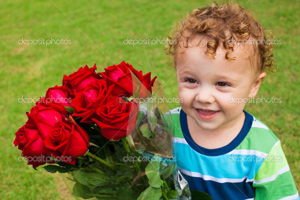 Happy child with a bouquet of red roses — Stock Photo © altanaka #12698077