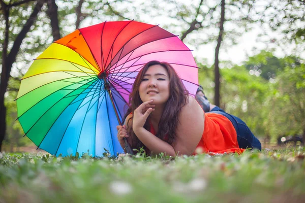 Happy fatty woman with umbrella - Stock Image - Everypixel