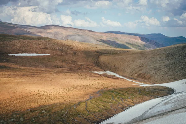 Sunny mountain desert relief with long glacier on slope in sunlight ...