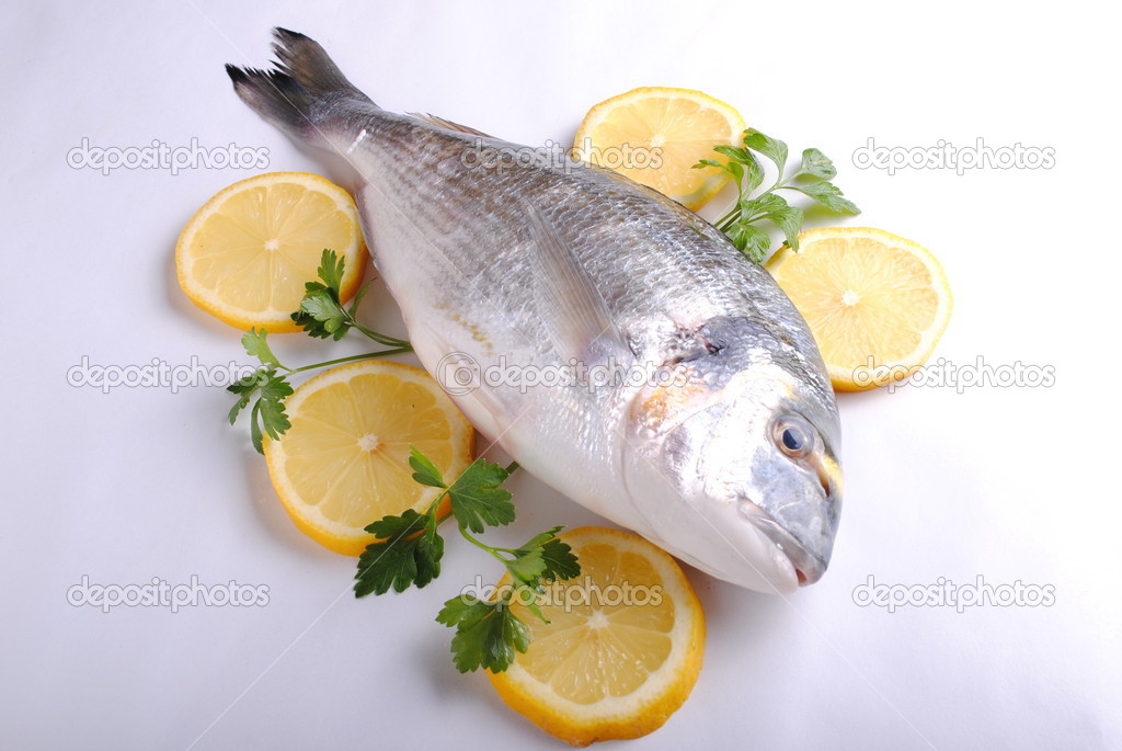 Raw sea fish with lemon slices and parsley Stock Photo by ©ilposeidone ...