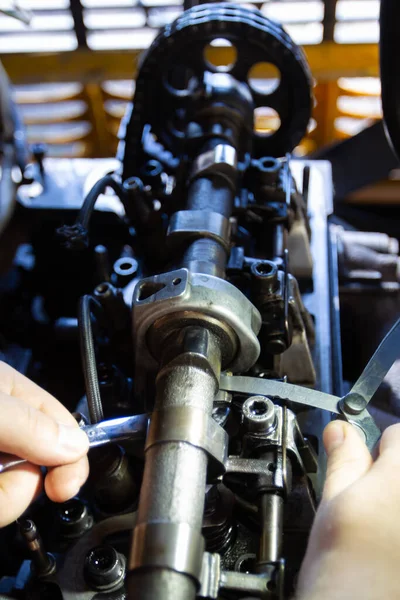 Mercedes diesel engine repair. Hands with a mechanic repairing Mercedes ...