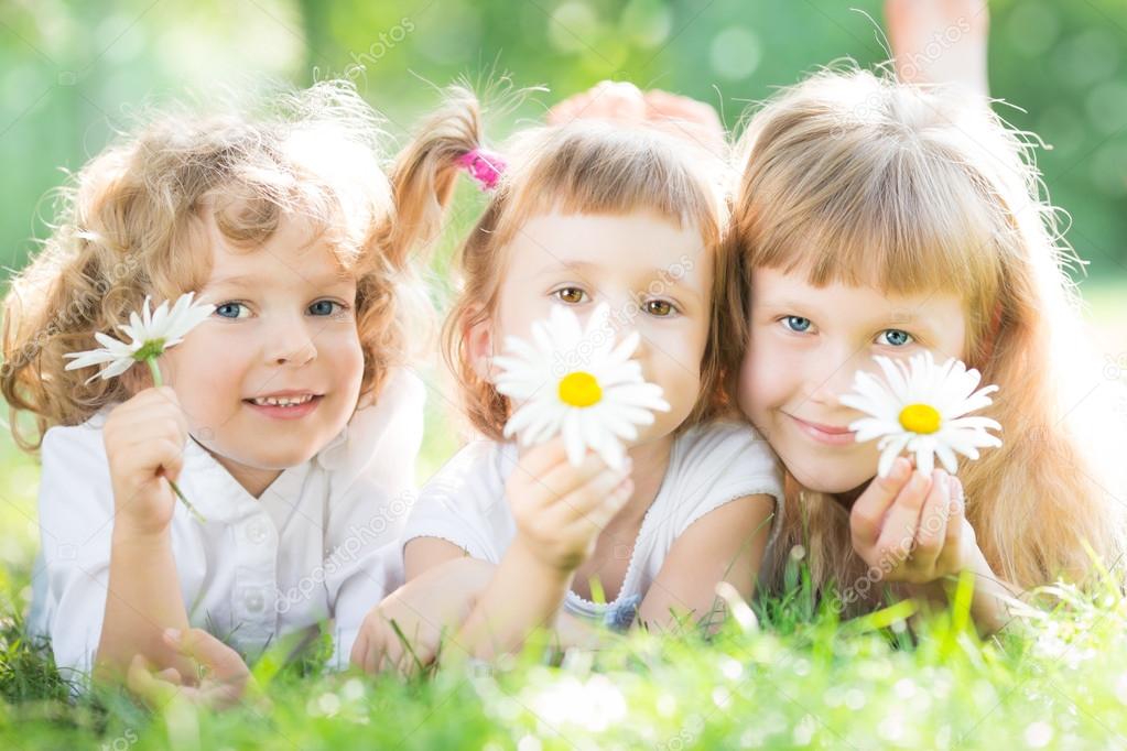 Children with flowers in park — Stock Photo © Yaruta #21384739