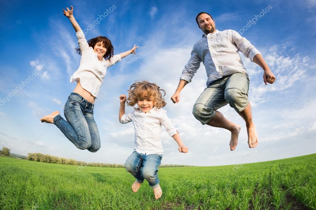 Happy active family jumping — Stock Photo © Yaruta #25537559