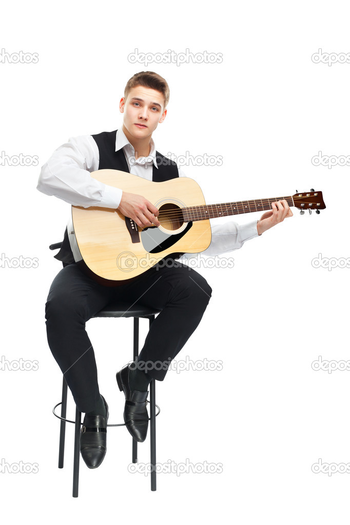 Young man playing on acoustic guitar Stock Photo by ©Gladkov 30754095