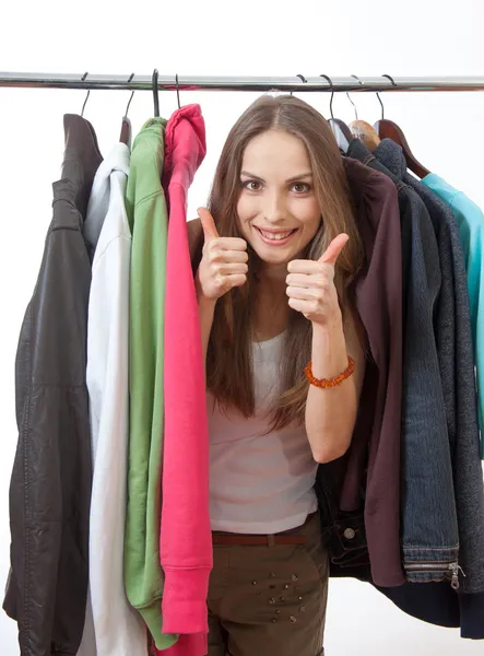 Young woman near rack with hangers - Stock Image - Everypixel
