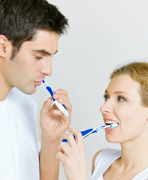 Cheerful young couple cleaning teeth together Stock Photo by ©g_studio ...