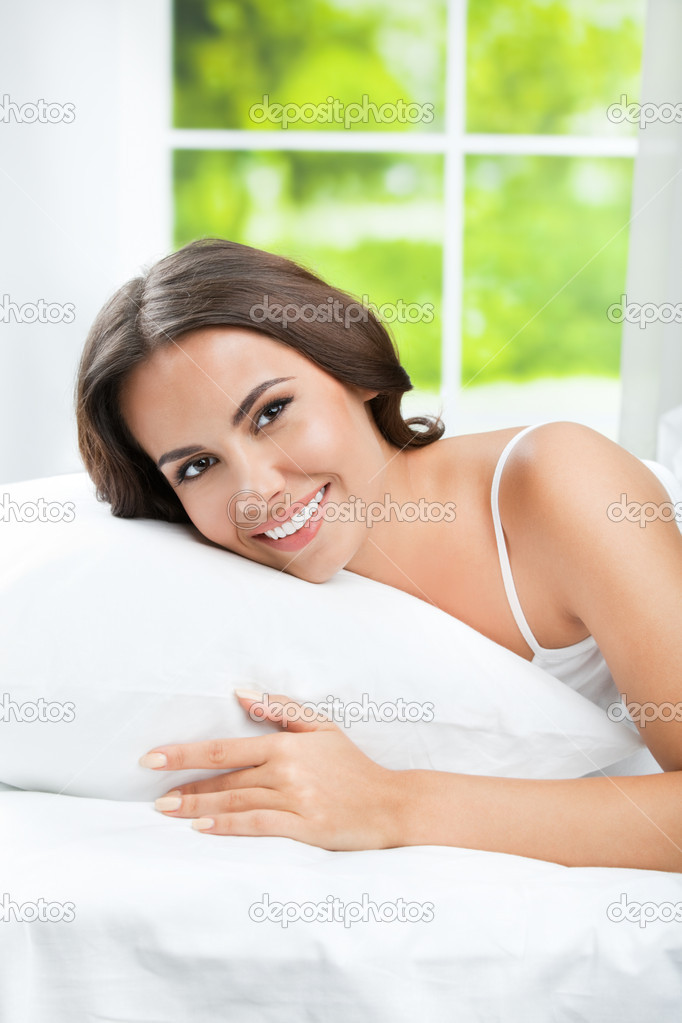 Young beautiful woman waking up, at bedroom — Stock Photo © g_studio ...