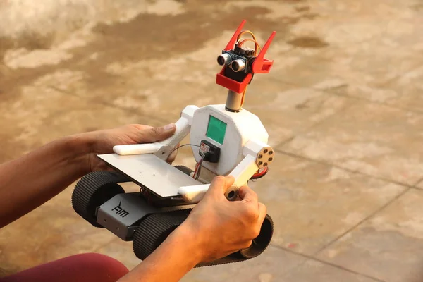 Hands Holding Remote Controlling Robot - Stock Image - Everypixel