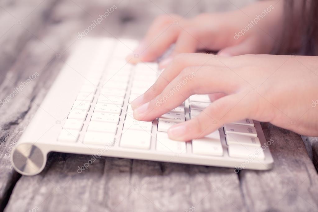 Close up girl hand typing keyboard on wood table — Stock Photo ...