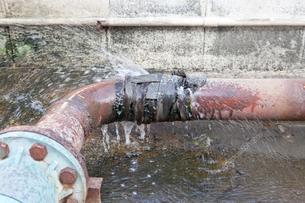 Old rusty pipe with leak and water spraying out — Stock Photo ...