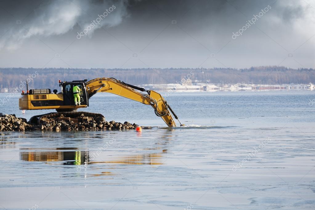 Bulldozer dredging in the sea — Stock Photo © lagereek #20159361