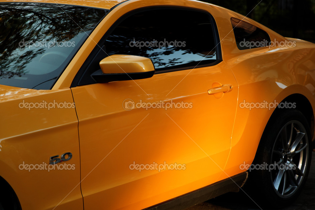 A fragment of the side of the luxury of modern yellow car in the ...