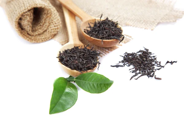 Wooden spoon with leaves tea and fresh green lemon leaf isolated ...