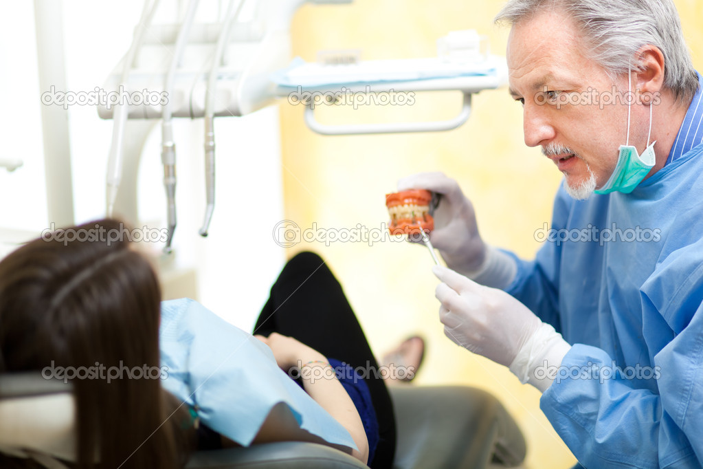 Dentist explaining a treatment — Stock Photo © minervastock #30021757