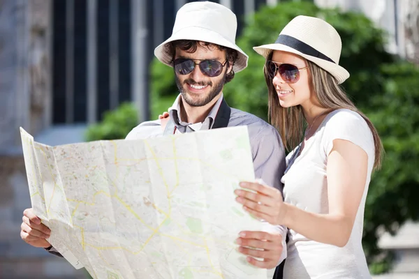 Couple of tourists holding a map - Stock Image - Everypixel