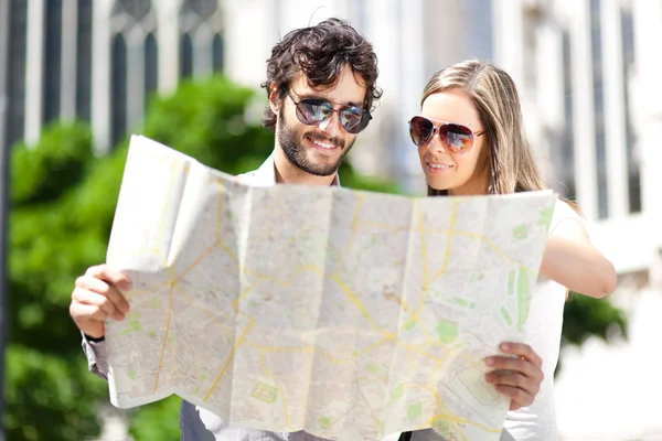 Tourists couple looking at a map - Stock Image - Everypixel