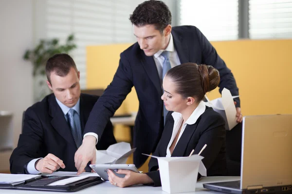 Supervisor checking on office workers work during lunch break — Stock ...