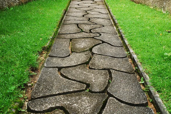 Stone path through a green grassy lawn — Stock Photo © kritiya #13515420