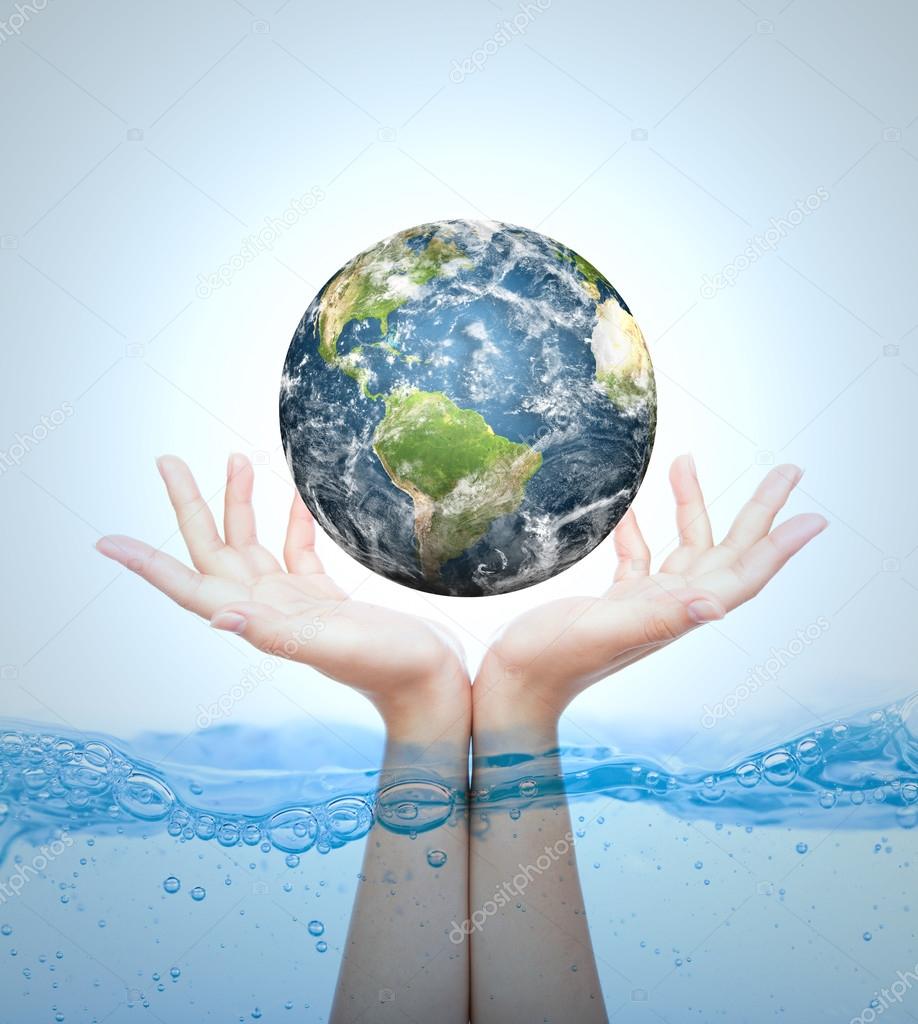 Earth in hand over water (Elements of this image furnished by NA ⬇ ...