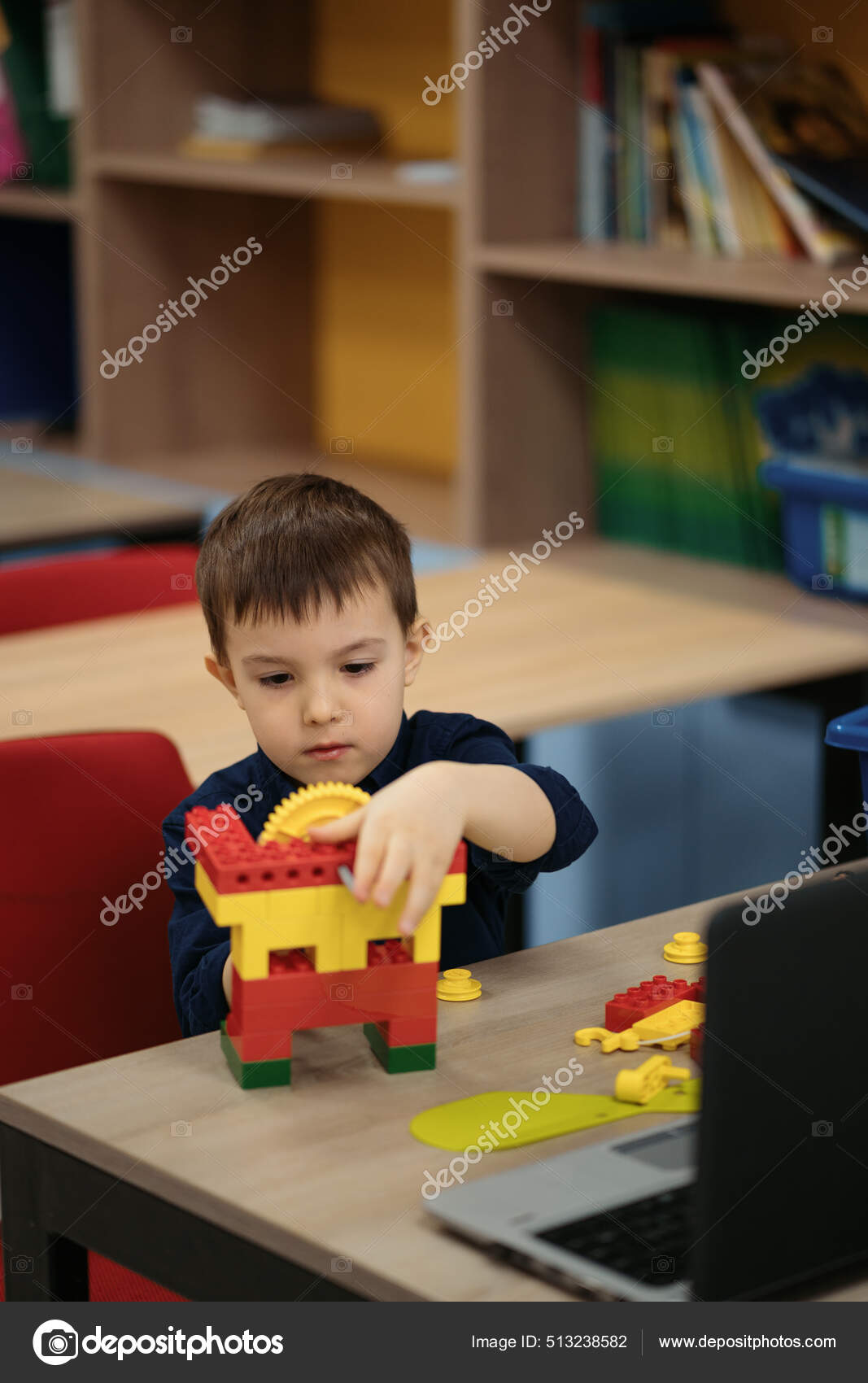 Little kid boy having fun with building and creating robot. — Stock ...