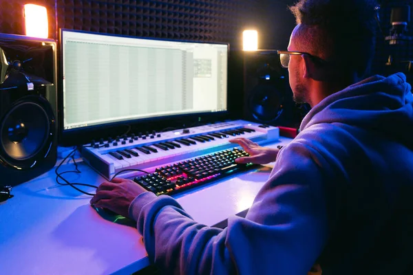 Producer, audio engineer uses a control panel and screen to record a ...