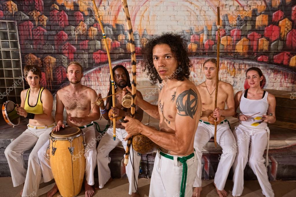 Latino Capoeira Performer with Group — Stock Photo © creatista #36161455