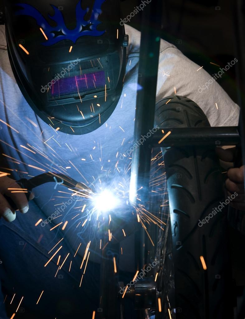 Welder working on motorcycle Stock Photo by ©creatista 39630083
