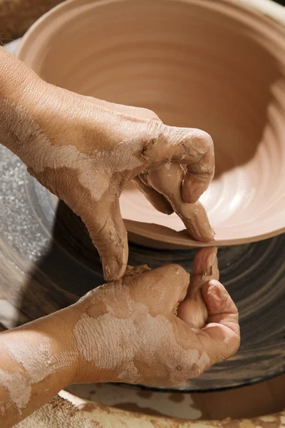 Hands forming clay on wheel - Stock Image - Everypixel