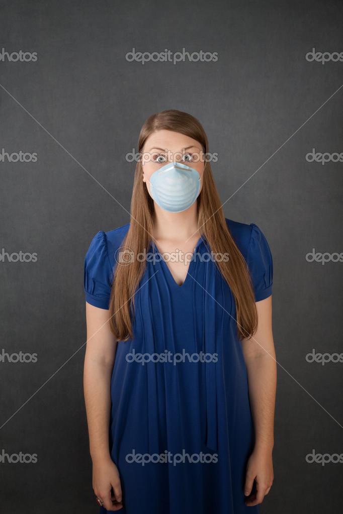 Scared woman wearing surgical mask Stock Photo by ©creatista 40636017