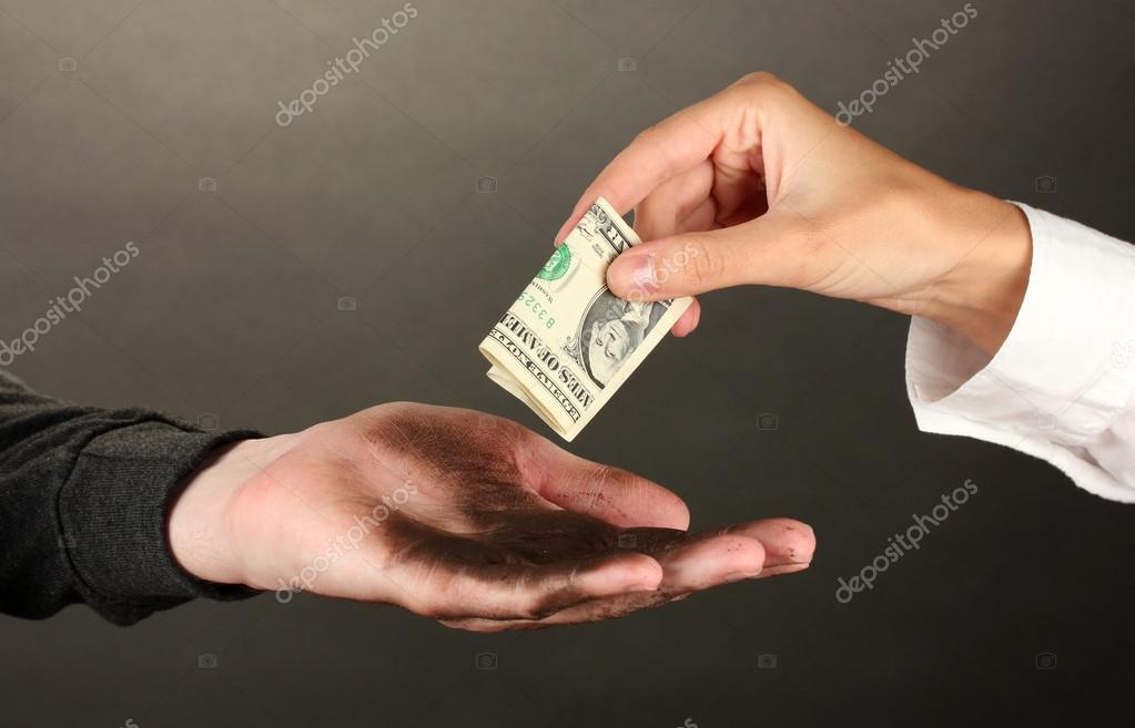 Helping the homeless, on black background close-up Stock Photo by ...